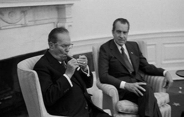 Josip Broz Tito smokes a Cuban cigar during a meeting with U.S ...