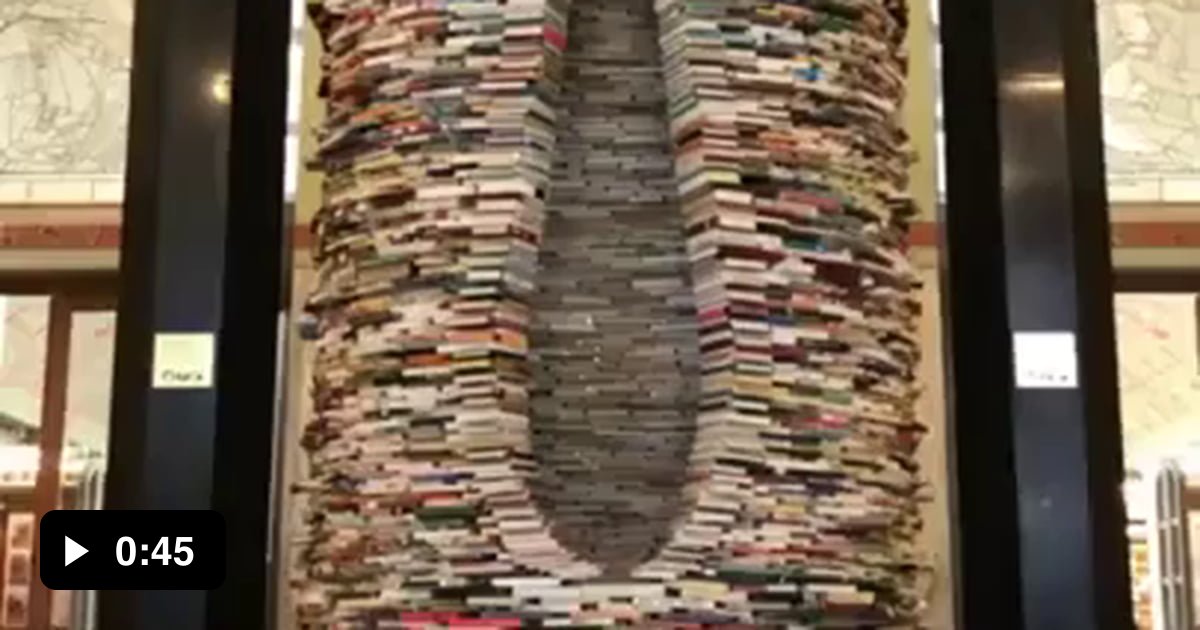 Infinite book tower in Prague. There's a mirror on the bottom and top ...