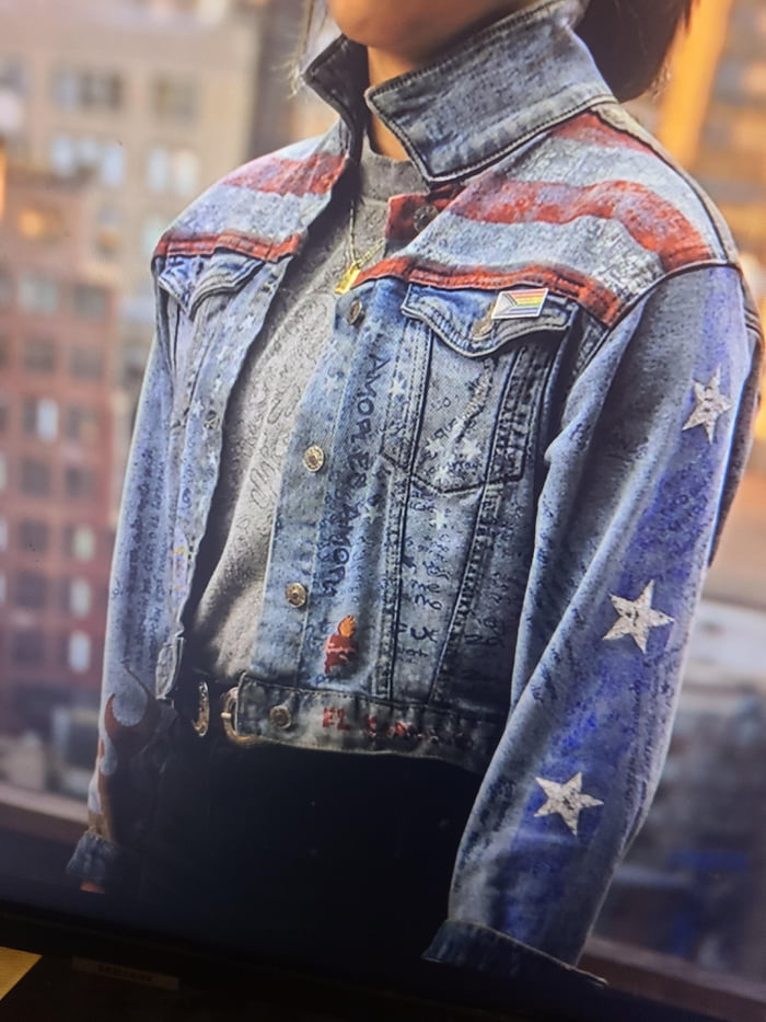 Theories about the writing on her Jacket? - 9GAG