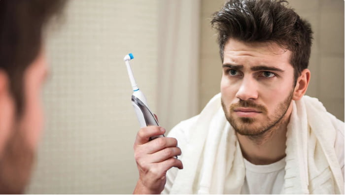 Sad man unable to brush teeth after failing to pay monthly subscription on smart toothbrush - 9GAG