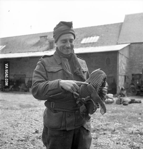 WW2 Canadian soldier pointing out a sniper rifle bullet hole in his ...