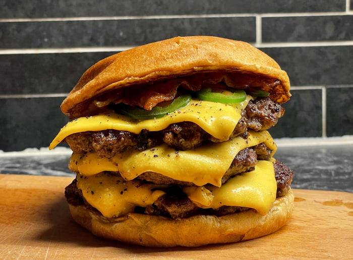 Homemade triple hamburger with caramelized onions, bacon, and fresh ...