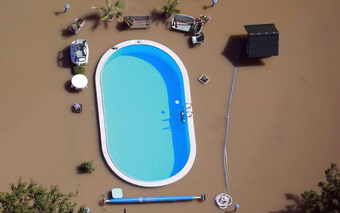 Swimming pool untouched by dirty flood waters - 9GAG