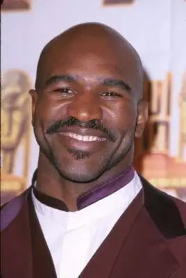 Evander Holyfield had a face as he was a priest in the morning and a ...