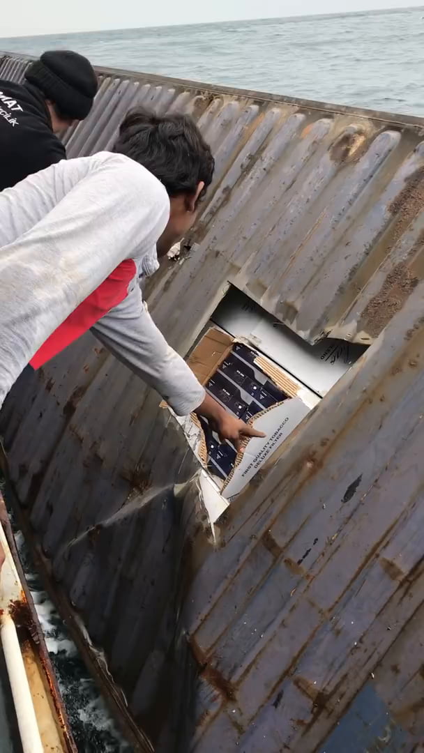 People on a ship came across a broken but afloat container in the ...