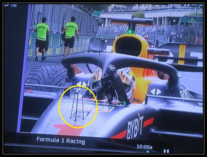 OK F1 fans: What's this gadget directly in front of the drivers view? Mounted on a wire 'tri-pod ...