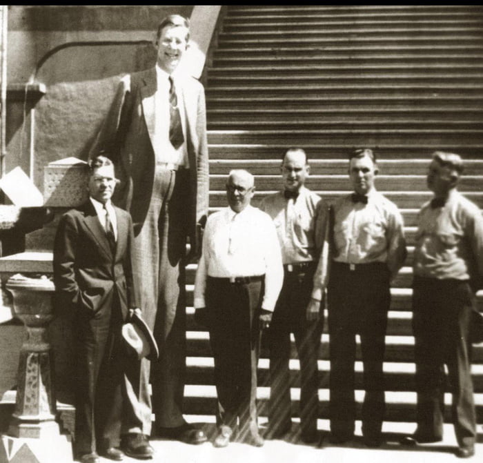 The World's First 6-foot Tall Man standing next to 5'11" men, (1928) - 9GAG