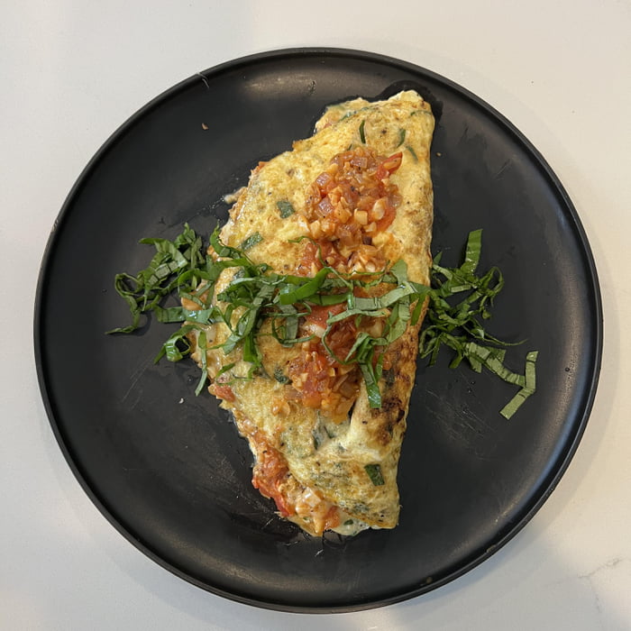 Egg omelette with sautéed onions, garlic, and tomato with mozzarella ...