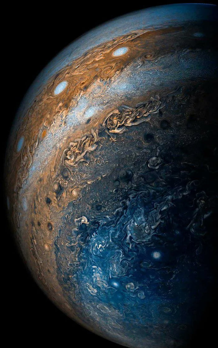 This enhanced-color image of Jupiter’s bands of light and dark clouds ...