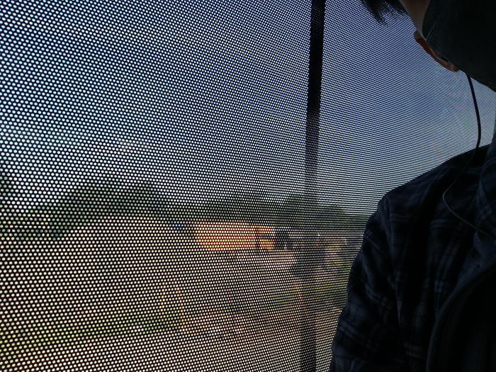 This bus's windows has a screen like print that makes it difficult for ...