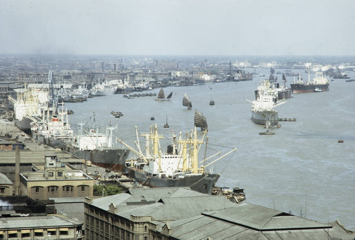 Modern cargo freighters docking alongside traditional Chinese junks in ...