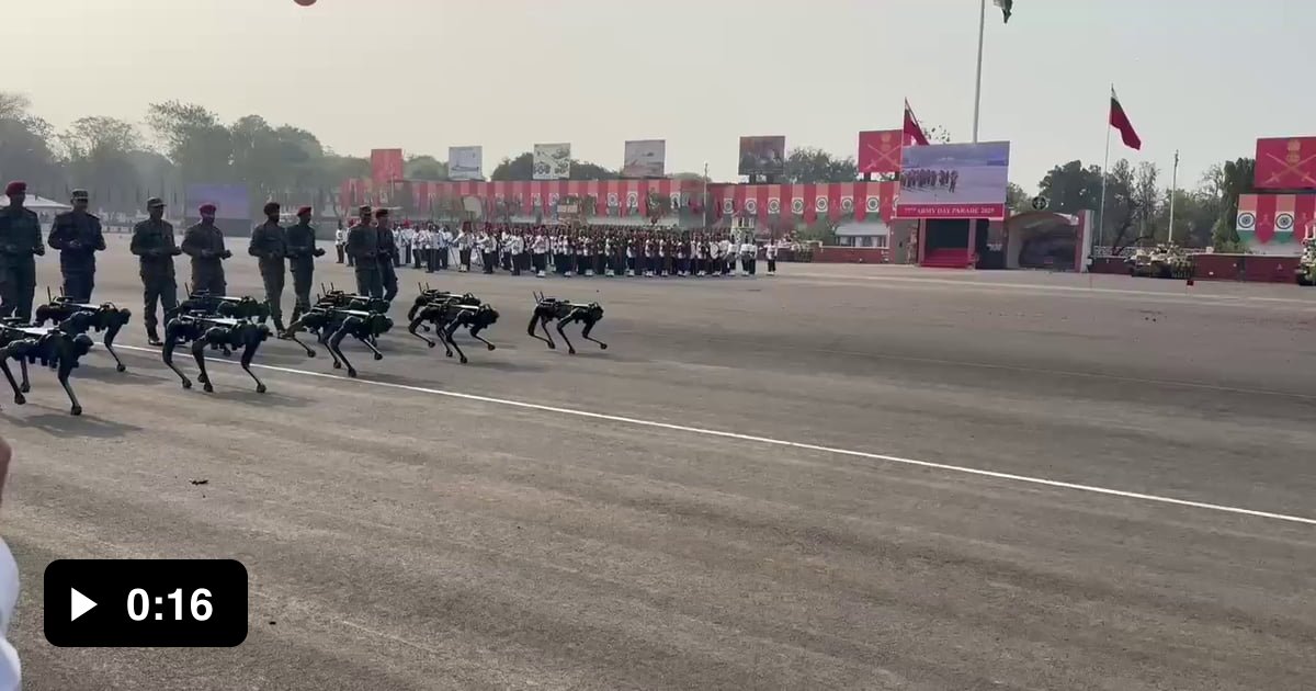 The footage shows robot dogs walking along the parade ground, followed ...