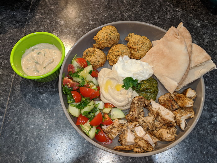 Shawarma inspired chicken, falafel, and israeli salad served with pita ...