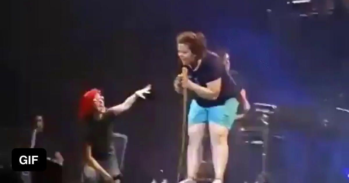 Fan falls on stage at concert and the band all lay down next to her. - 9GAG