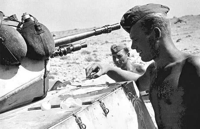German armored personnel of the Afrika Korps fry eggs on the hull of a ...