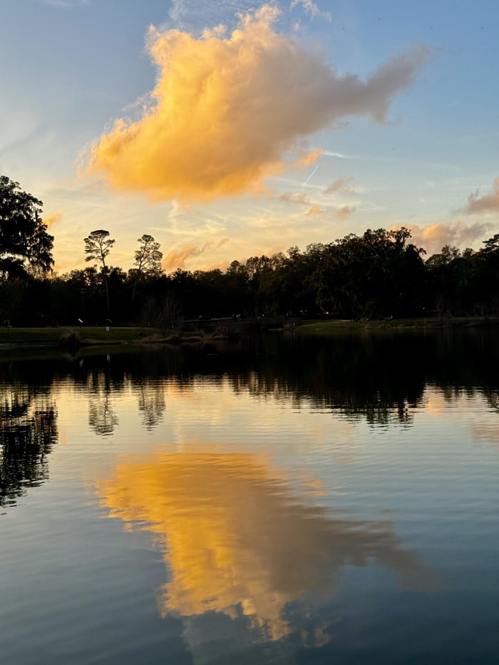 Fluffy cloud reflecting at sunset over a local pond - 9GAG
