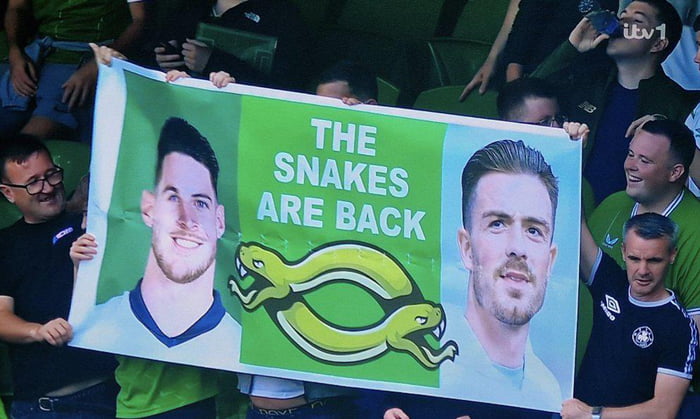Irish fans holding a poster which depicts Rice and Grealish as snakes ...