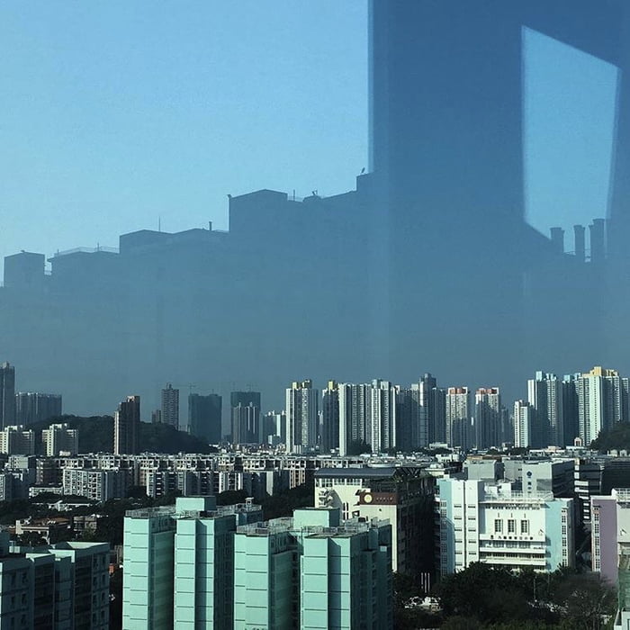 This photo by Chien Chi Chang shows a reflection on a window making it ...