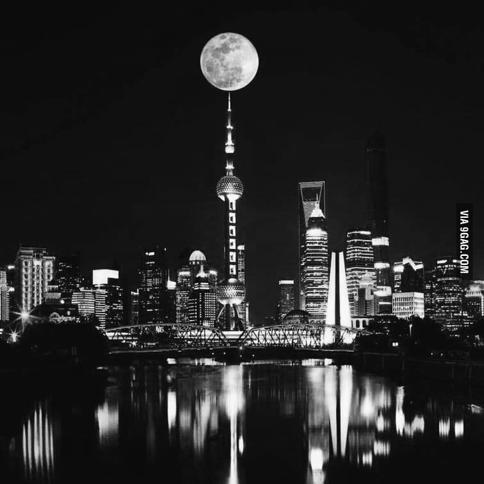 Moon perfectly floating above the pearl tower in Shanghai. - 9GAG