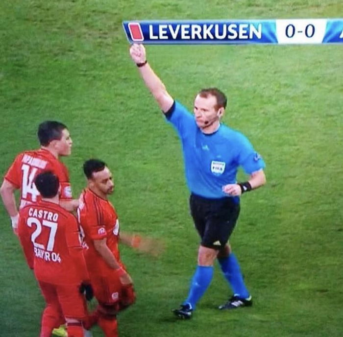 Referee (don't know how to spell it, shut up) holds red card in the ...