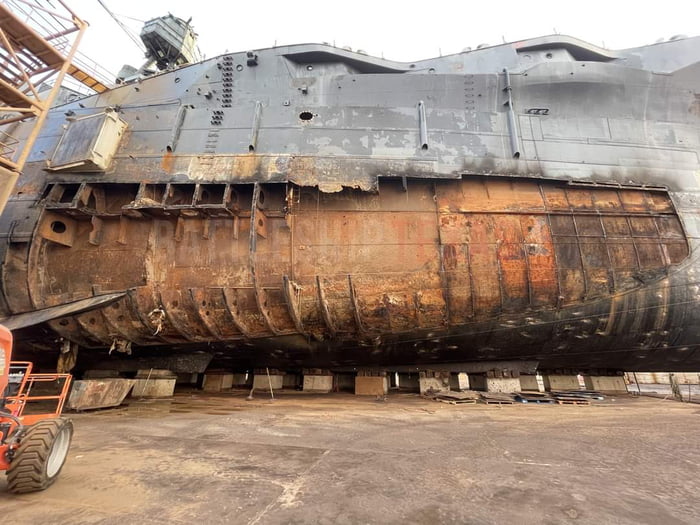 Lots of work being done removing the rusted panels of the torpedo ...