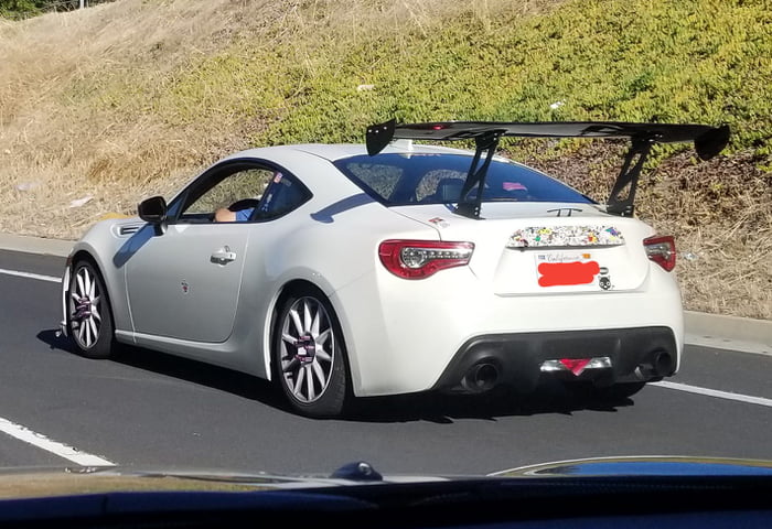 This car has a comically small spoiler under it's comically large ...
