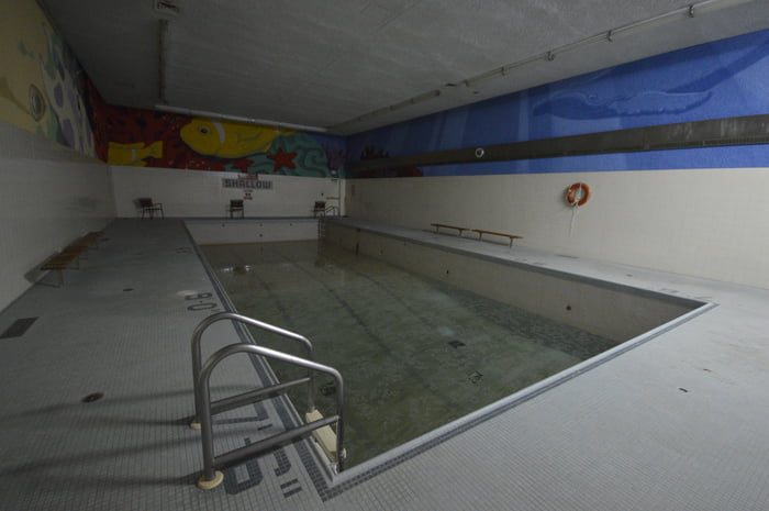 A Moldy, Half Filled Pool in a Derelict and Crumbling Building Owned ...