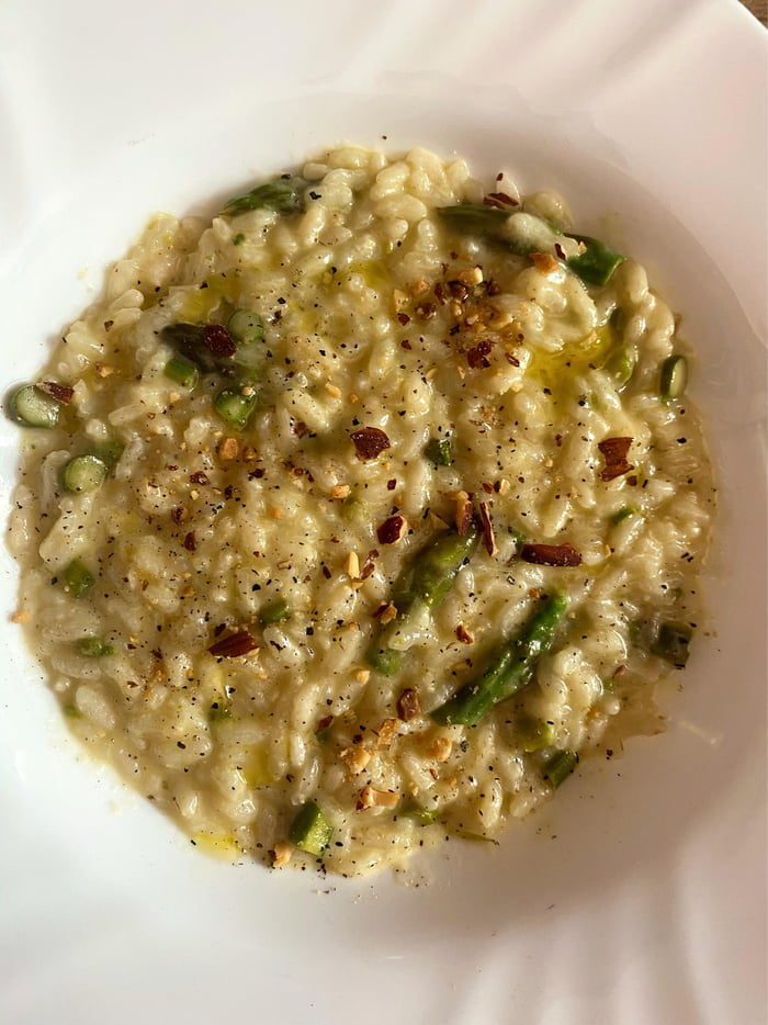 Risotto with asparagus, finished with almonds, oil and pepper - 9GAG