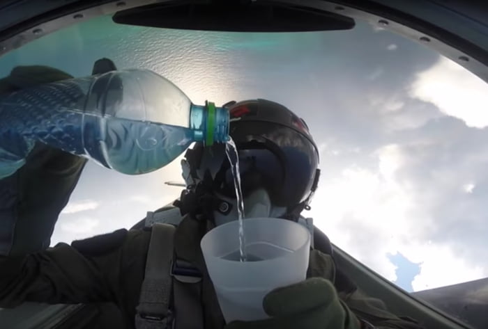 A fighter pilot pouring water "up" - 9GAG