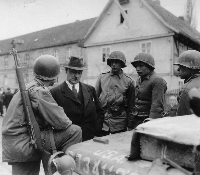 90th Infantry Division soldiers go over a list of demands regarding the ...