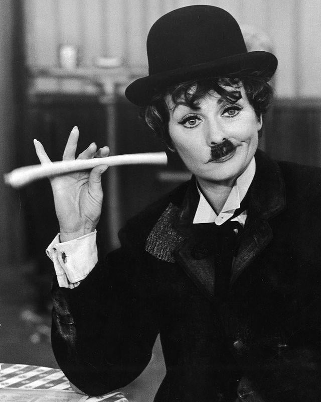 Lucille Ball is pictured here impersonating Charlie Chaplin holding a ...