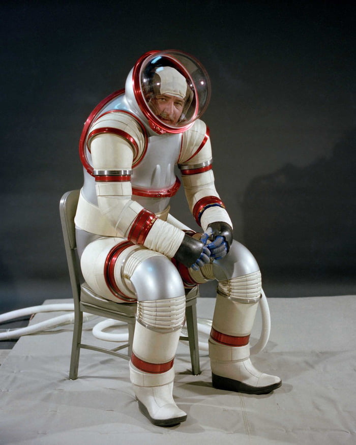 NASA designer Vic Vykukal demonstrates the AX-3 hard-shell spacesuit ...