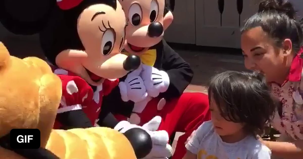 Minnie and Mickey Mouse talk to a deaf boy in sign language at ...