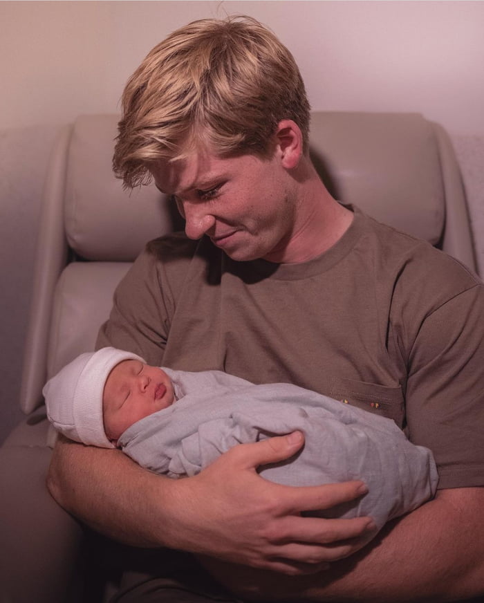 Robert Irwin holding his new niece, Grace - 9GAG