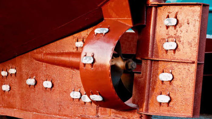 A ship’s hull is studded with metal bars (sacrificial anodes) to ...
