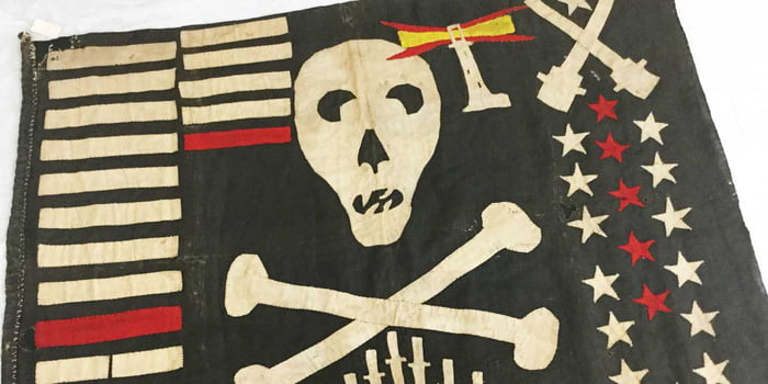 An example of a Jolly Roger with symbols depicting action with an enemy ...