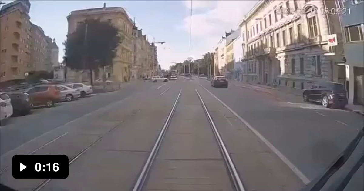 Woman crosses the road and is almost run over by a tram, doesn't even ...