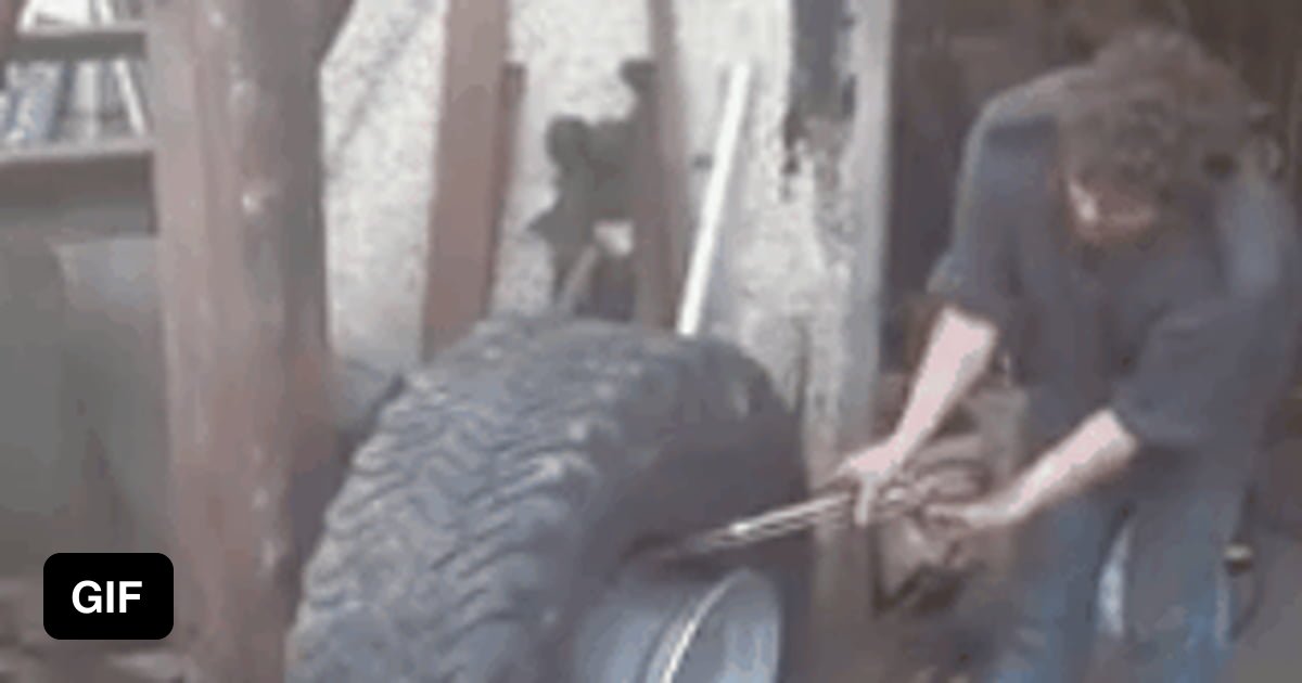This is the manliest way to put the tire on the rim I have ever seen - 9GAG