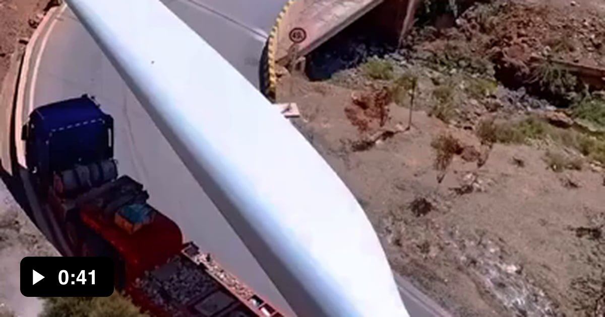 A giant wind turbine blade being transported through the mountains. - 9GAG