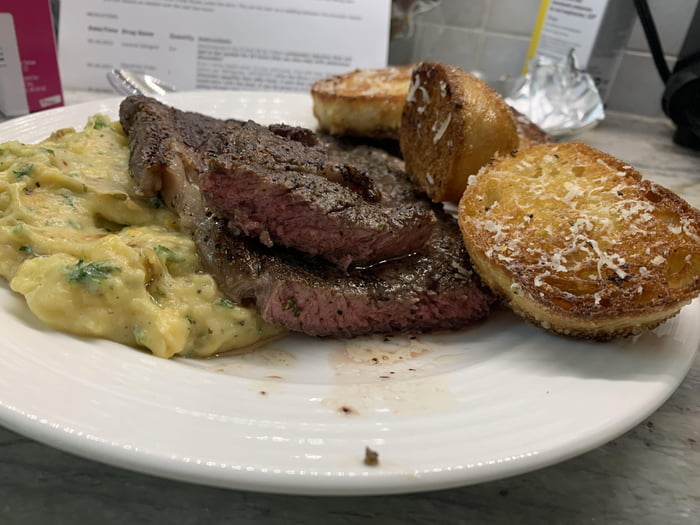 Grass-fed ribeye with cheddar mashed potatoes and parm-toasted baguette ...