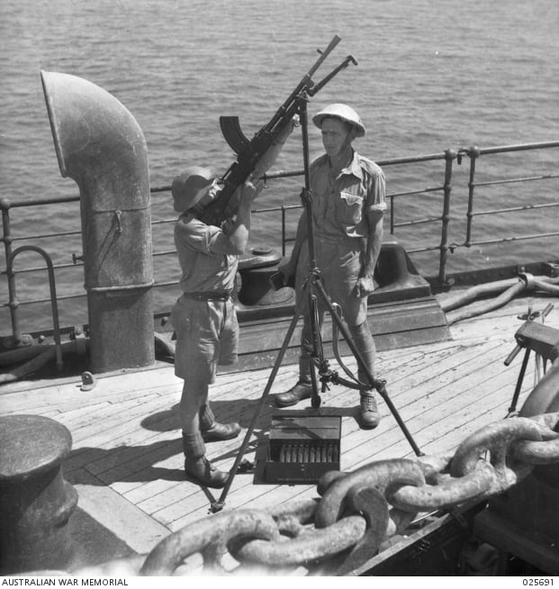 C 1942. A Bren gun crew manning their gun on board a troop ship ...