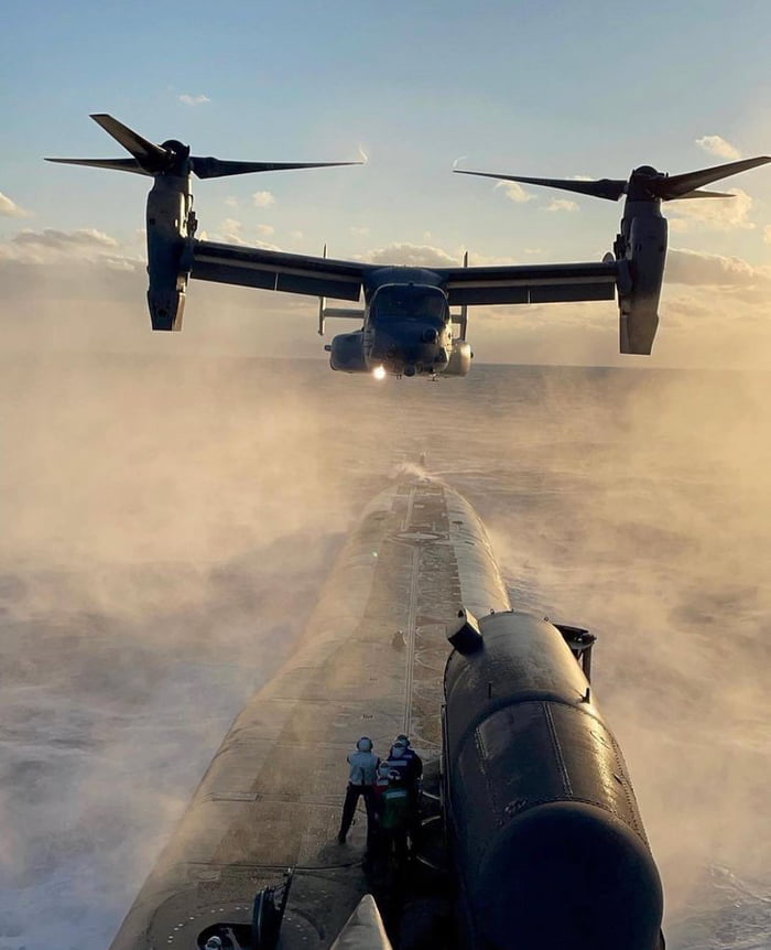 A Bell-Boeing CV-22 Osprey conducting submarine logistics operations ...