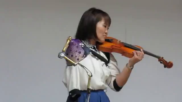A one-armed woman with a prosthetic arm plays the violin. YOLO you only ...