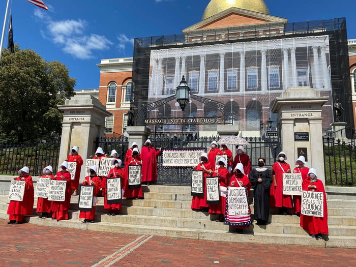 Boston Red Cloaks and MA Indivisibles at State House to stand in ...