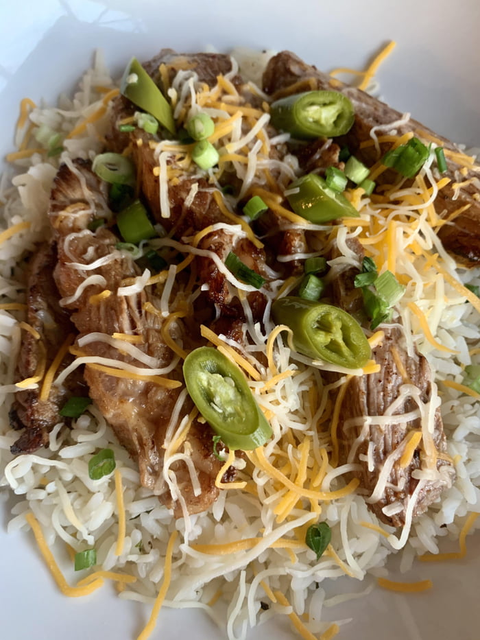 Carne asada over cilantro lime rice with cheddar jack and house-pickled ...