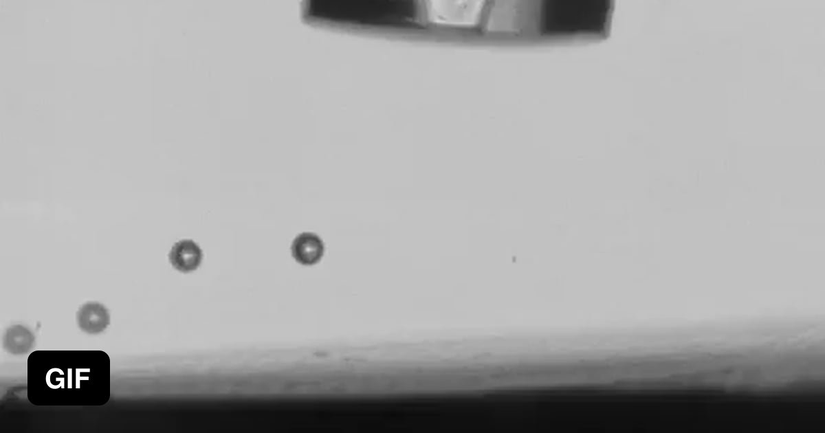 2 micro-droplets of isopropanol (about .04 mm in diameter) merge ...