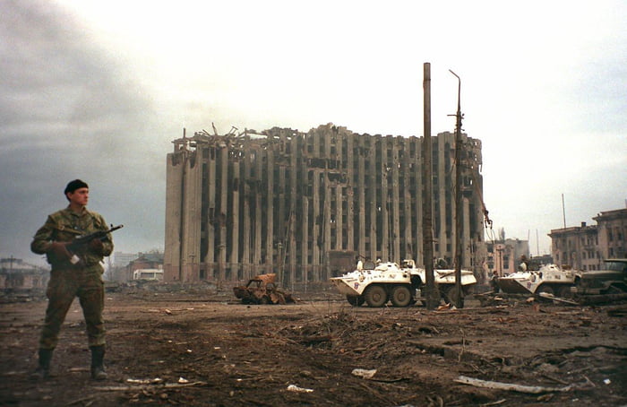 A Russian soldier against the background of the destroyed presidential ...