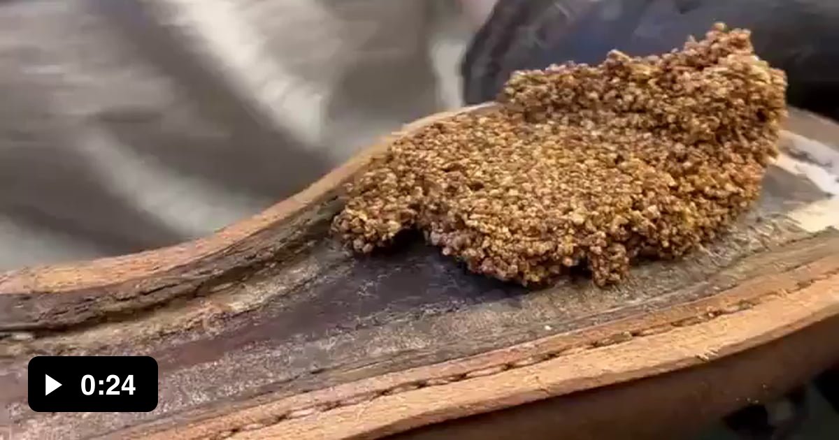 Spreading out cork paste in an insole of a shoe using hot spread knife ...