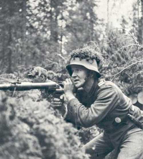 Finnish soldier manning a machine gun from his entrenched position ...