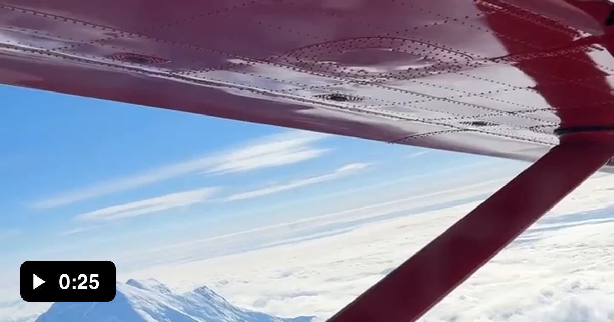 Climbers on the summit of Denali (formerly Mt McKinley) waving at a ...
